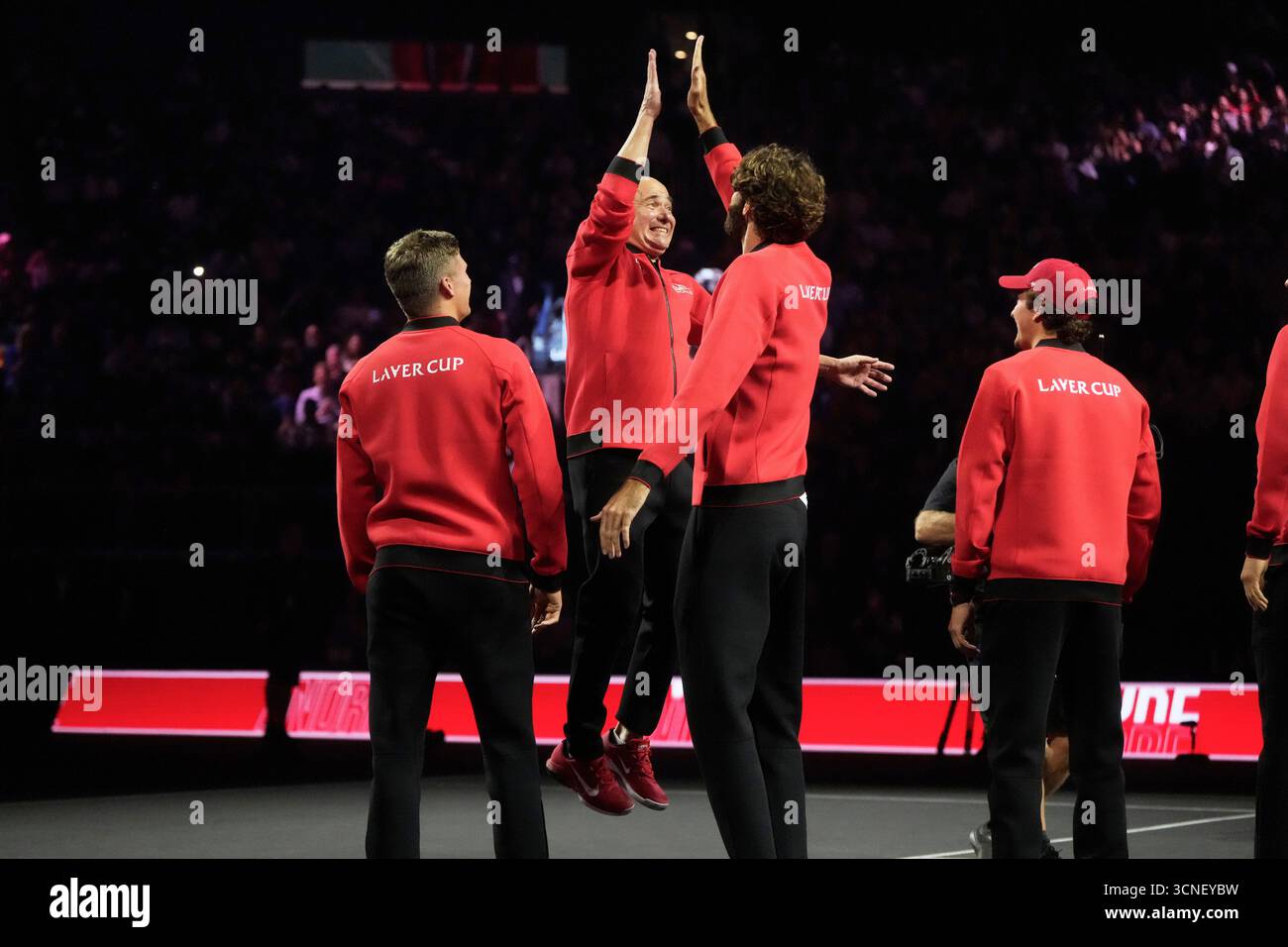 Team World captain Andre Agassi, middle, jumps to high five Reilly ...