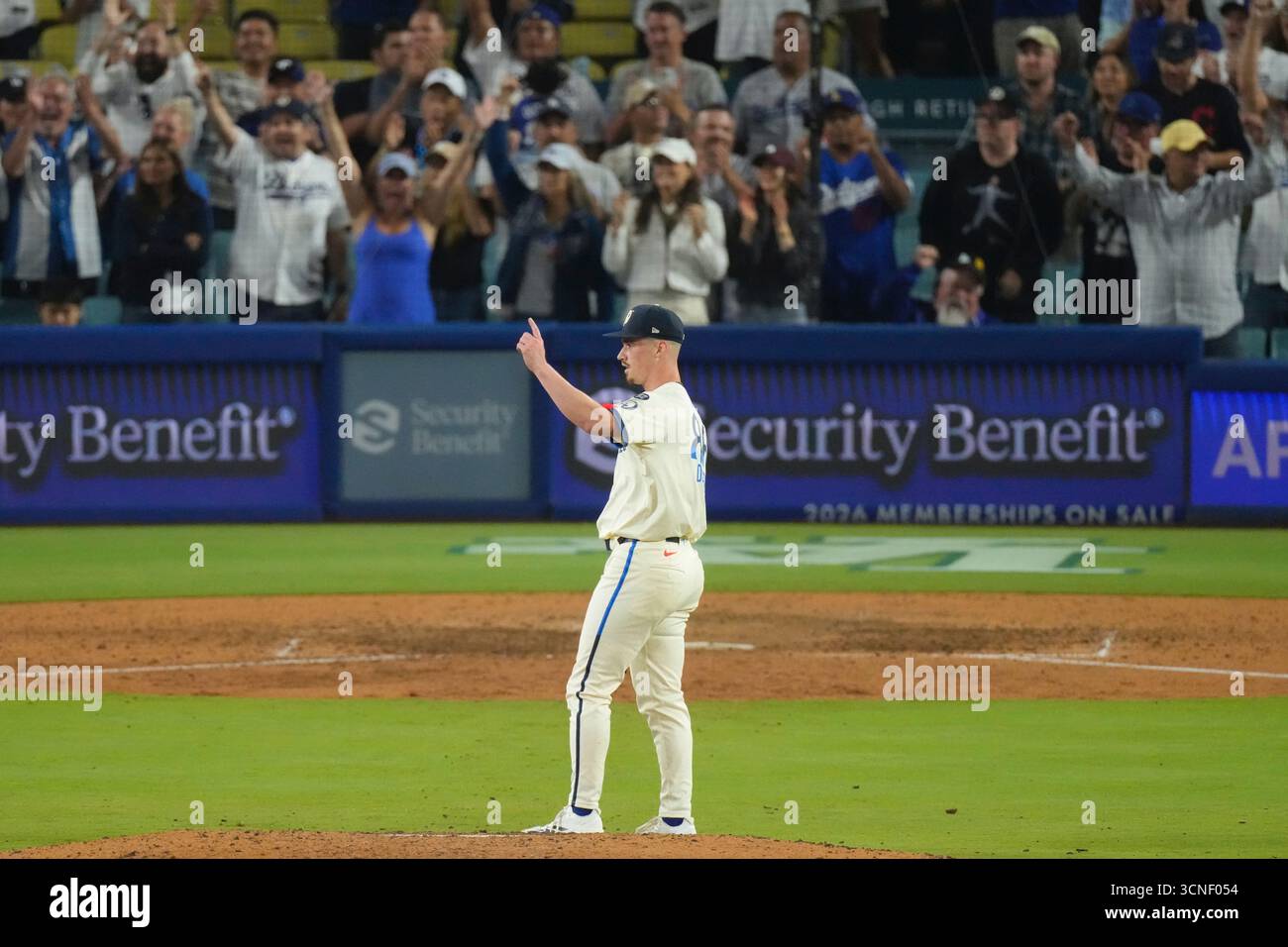 Los Angeles Dodgers relief pitcher Jack Dreyer gestures along with fans ...