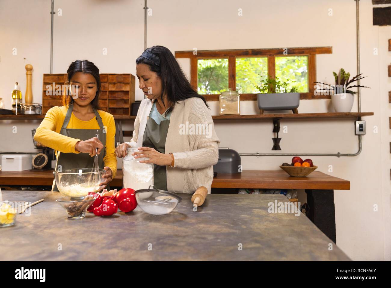 Diverse mother daughter stirring hi-res stock photography and images ...