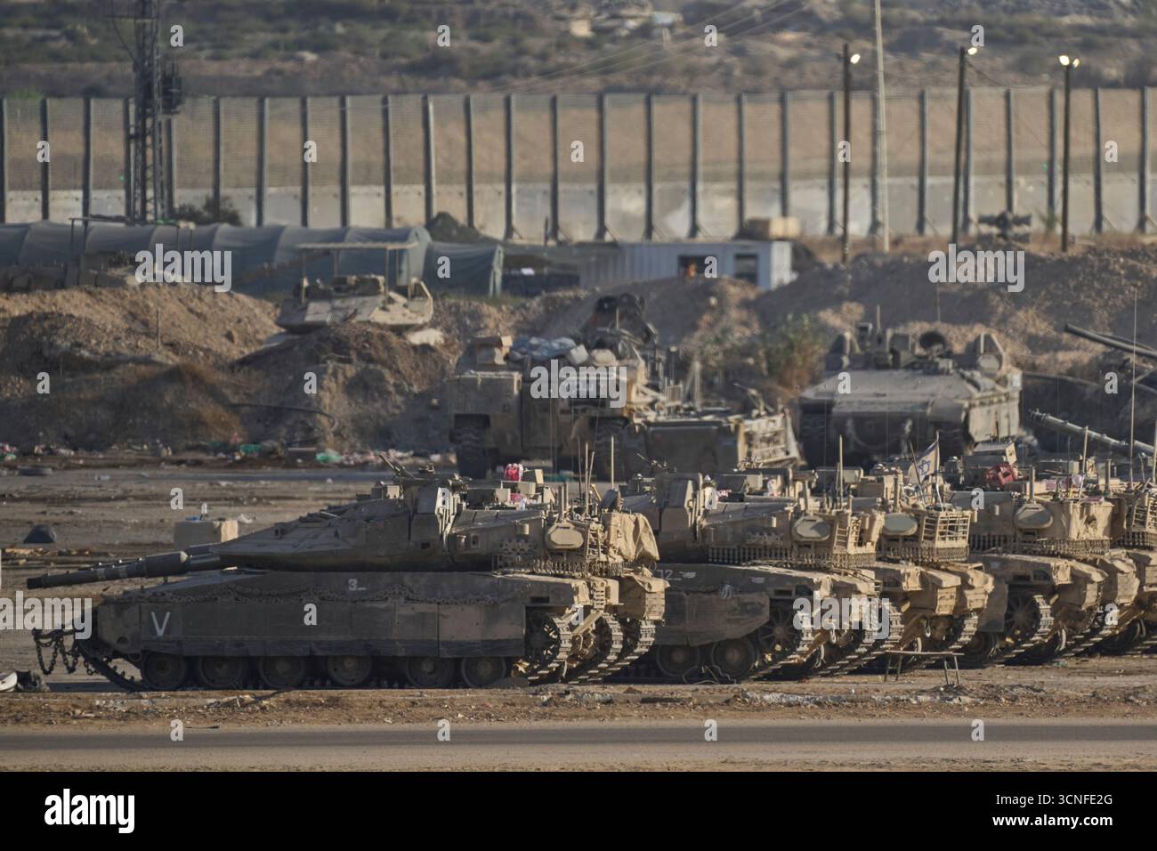 Israeli tanks at a staging area near the border with the Gaza Strip, in ...