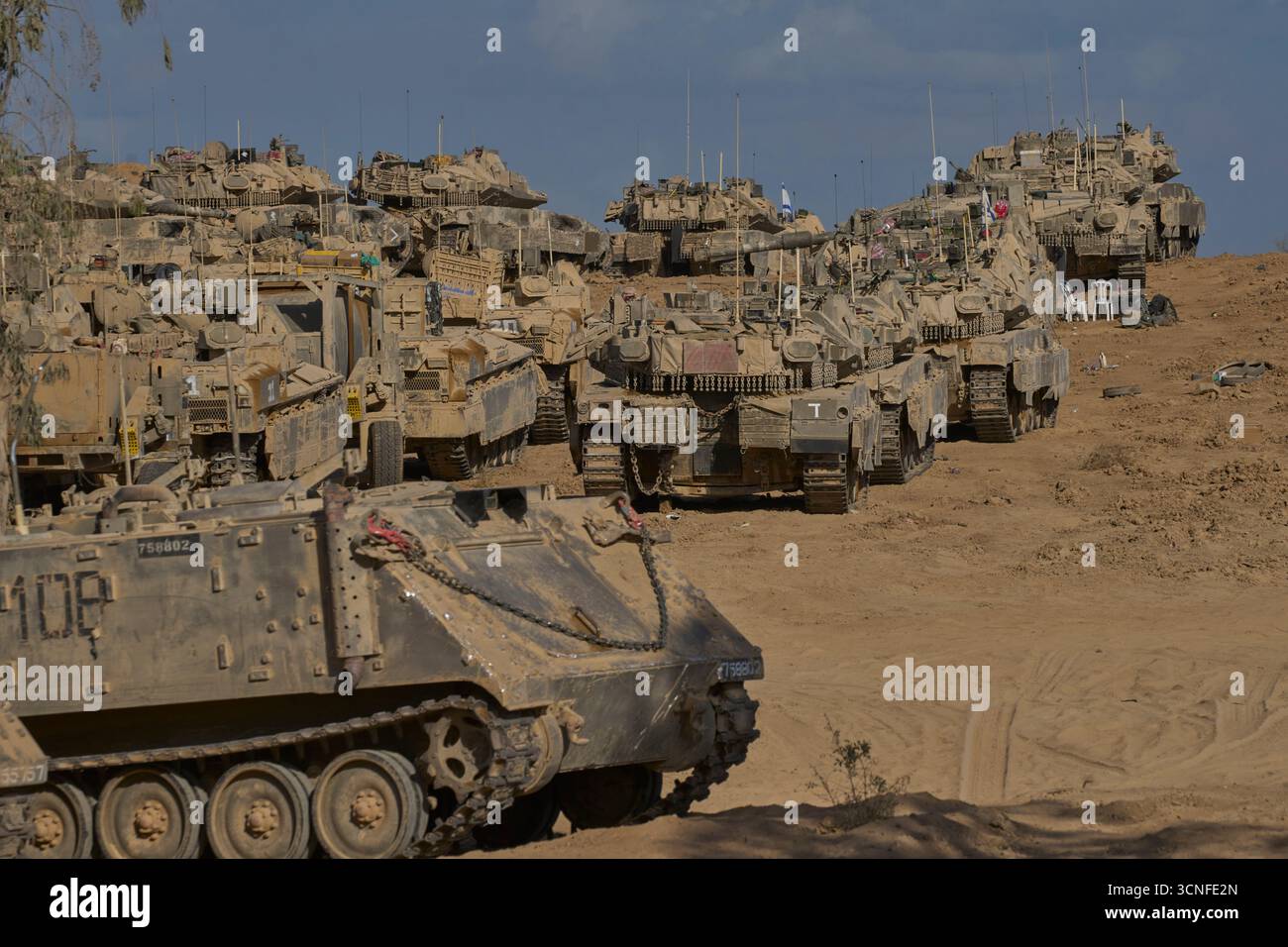 Israeli tanks at a staging area near the border with the Gaza Strip, in ...