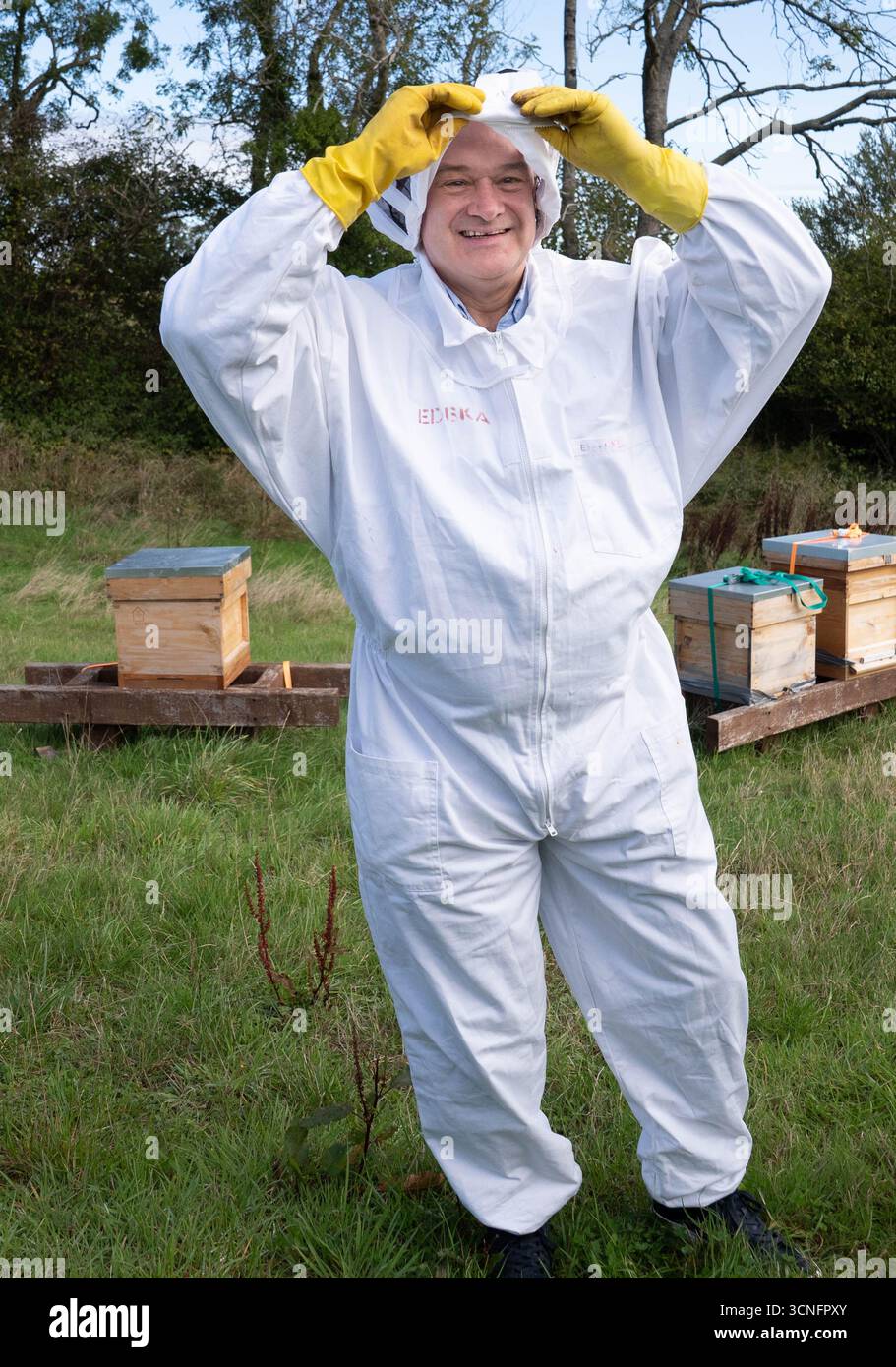 Liberal Democrats leader Sir Ed Davey assists with a bee inspection in ...