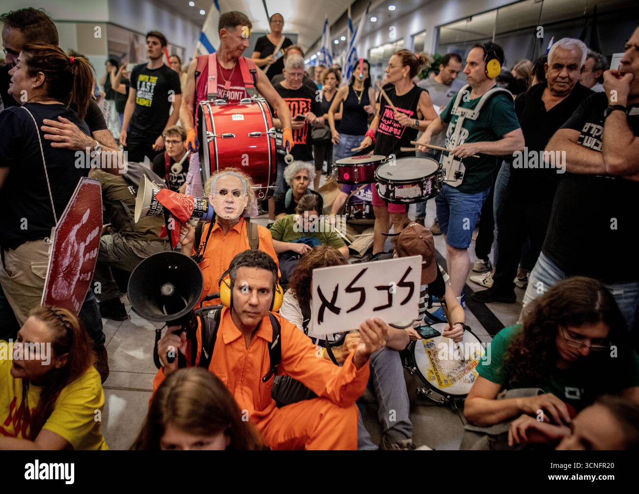 Israeli protesters play the drums during a protest out side a Likud ...