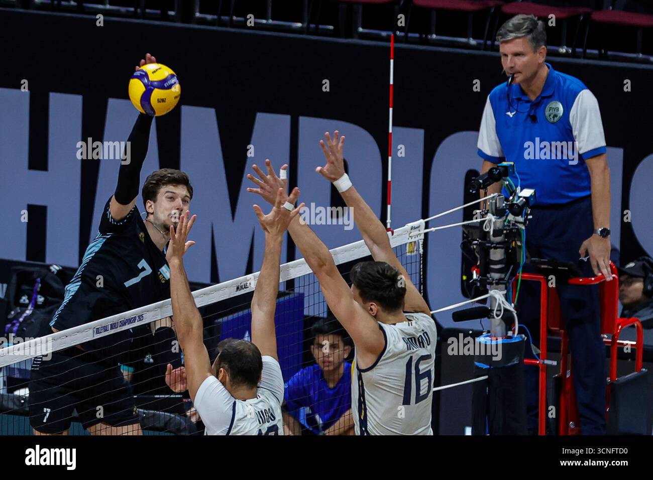 Luciano Palonsky of Argentina, left spikes the ball, during the round ...