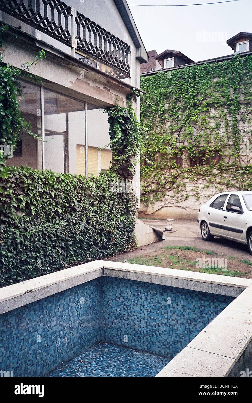 Small empty backyard pool with tiny blue tiles. No water. A quiet space ...