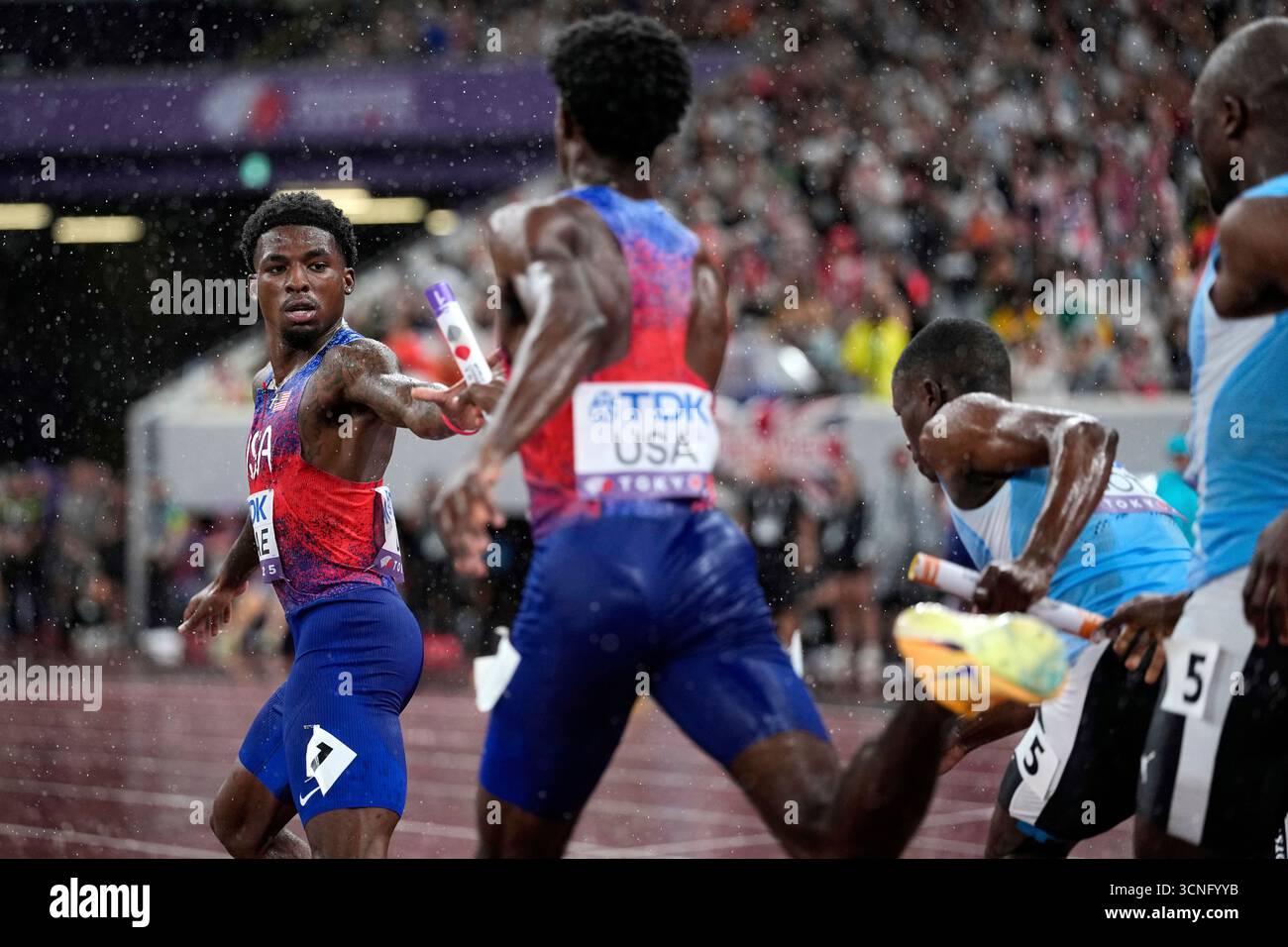 United States' Khaleb McRae and Botswana's Bayapo Ndori take the baton ...