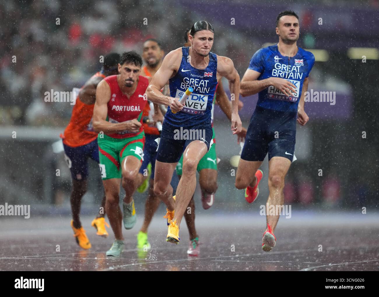 Great Britain's Toby Harries passes the baton to Lewis Davey in action ...