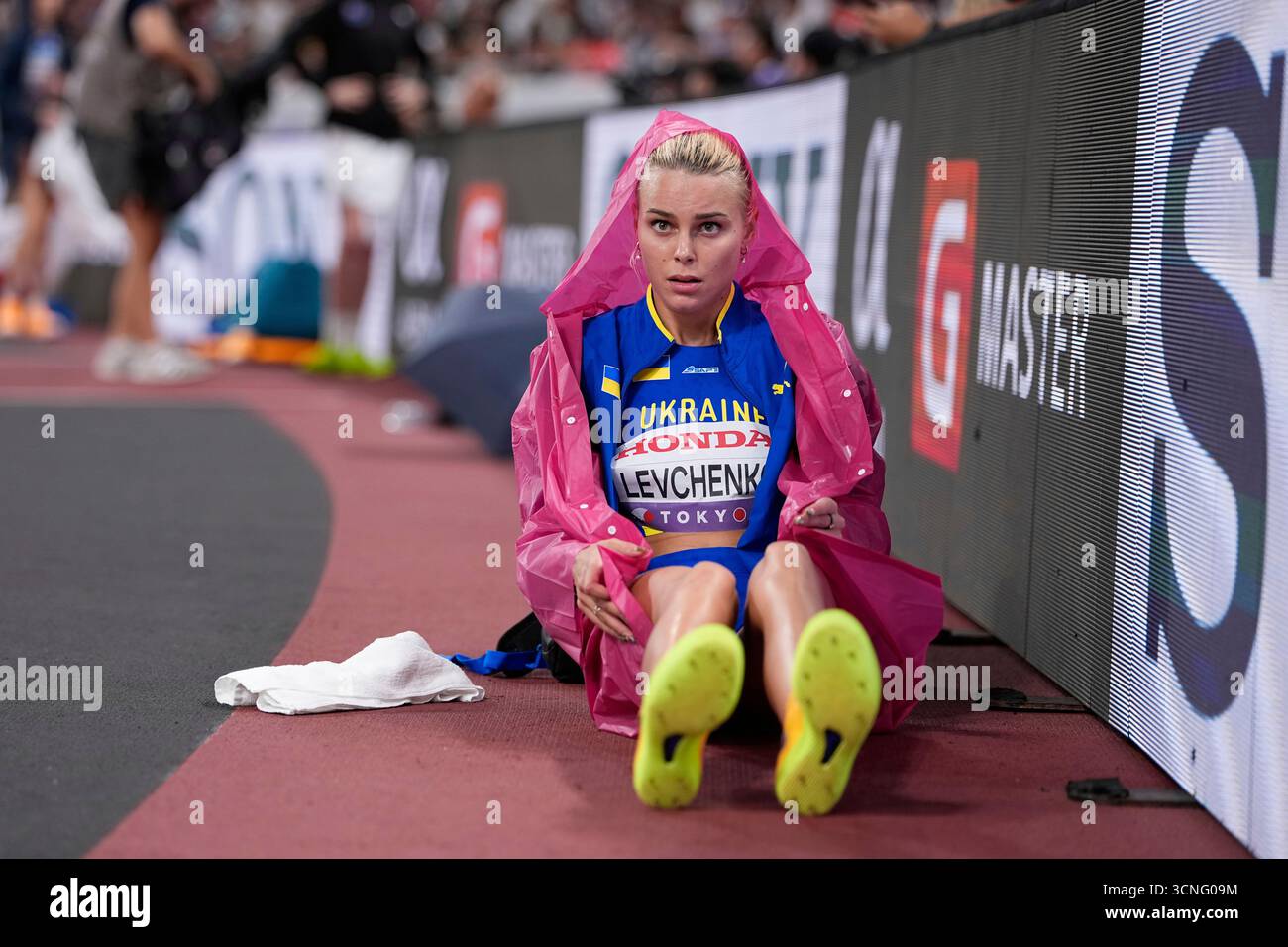 Ukraine's Yuliia Levchenko sits on the edge of the track as rain delays ...