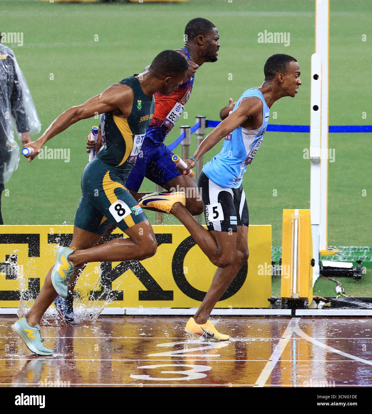 Busang Collen KEBINATSHIPI of Botswana (R) crosses the finish line to ...