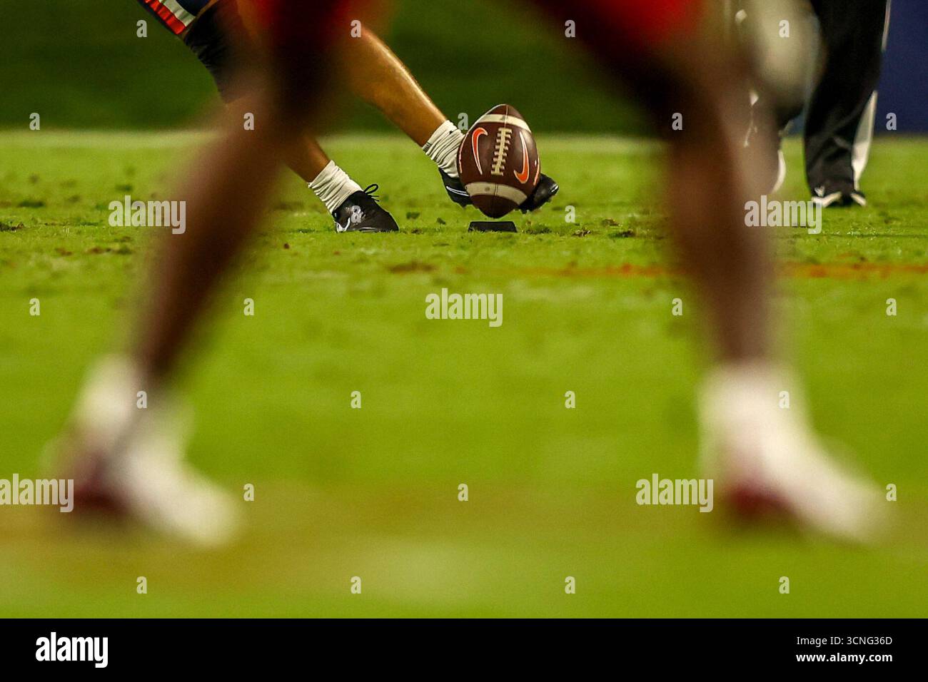 Charlottesville, VA: The ball is seen between the legs of the Stanford ...