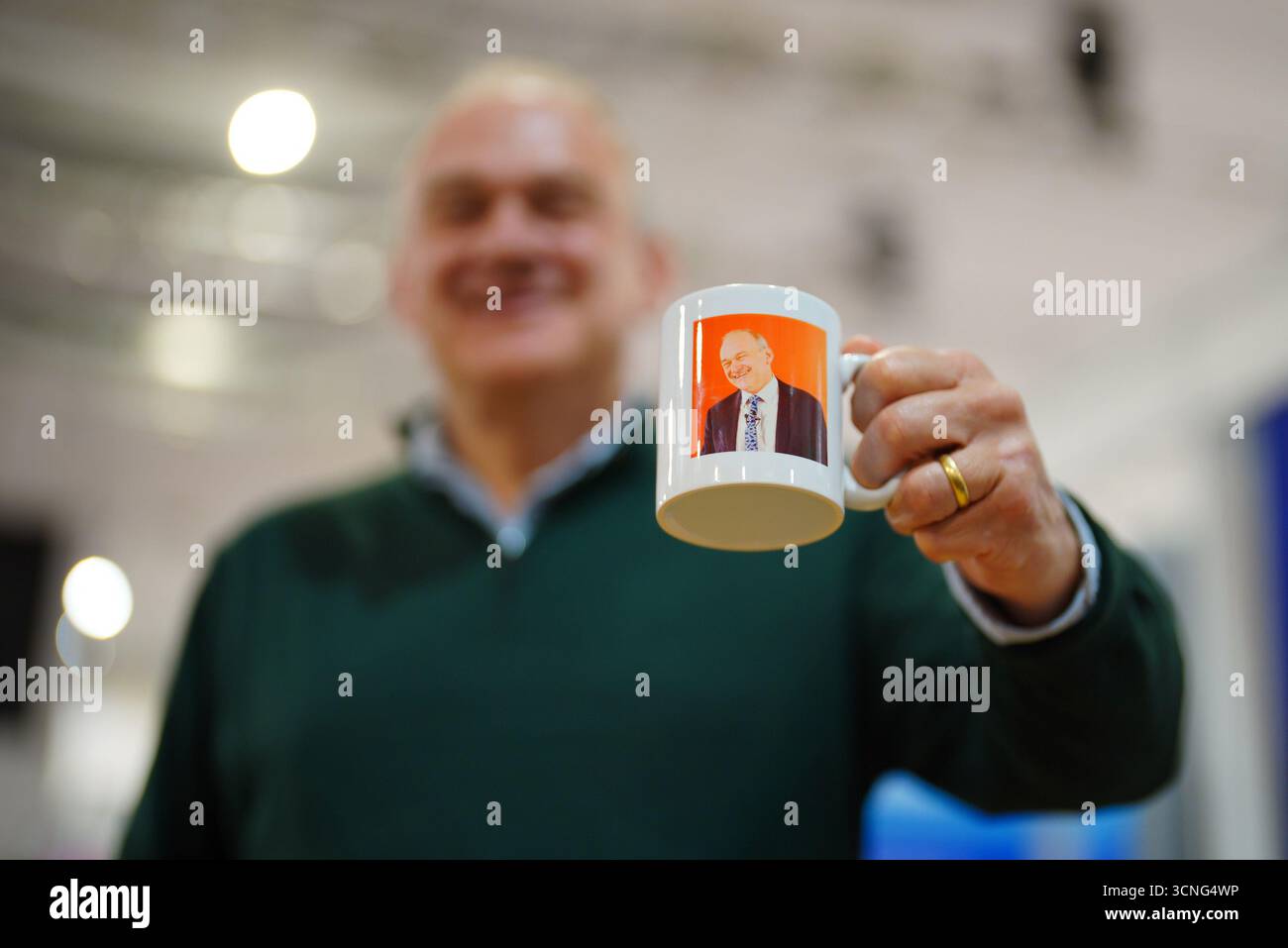Liberal Democrats leader Sir Ed Davey holds a mug featuring his image ...