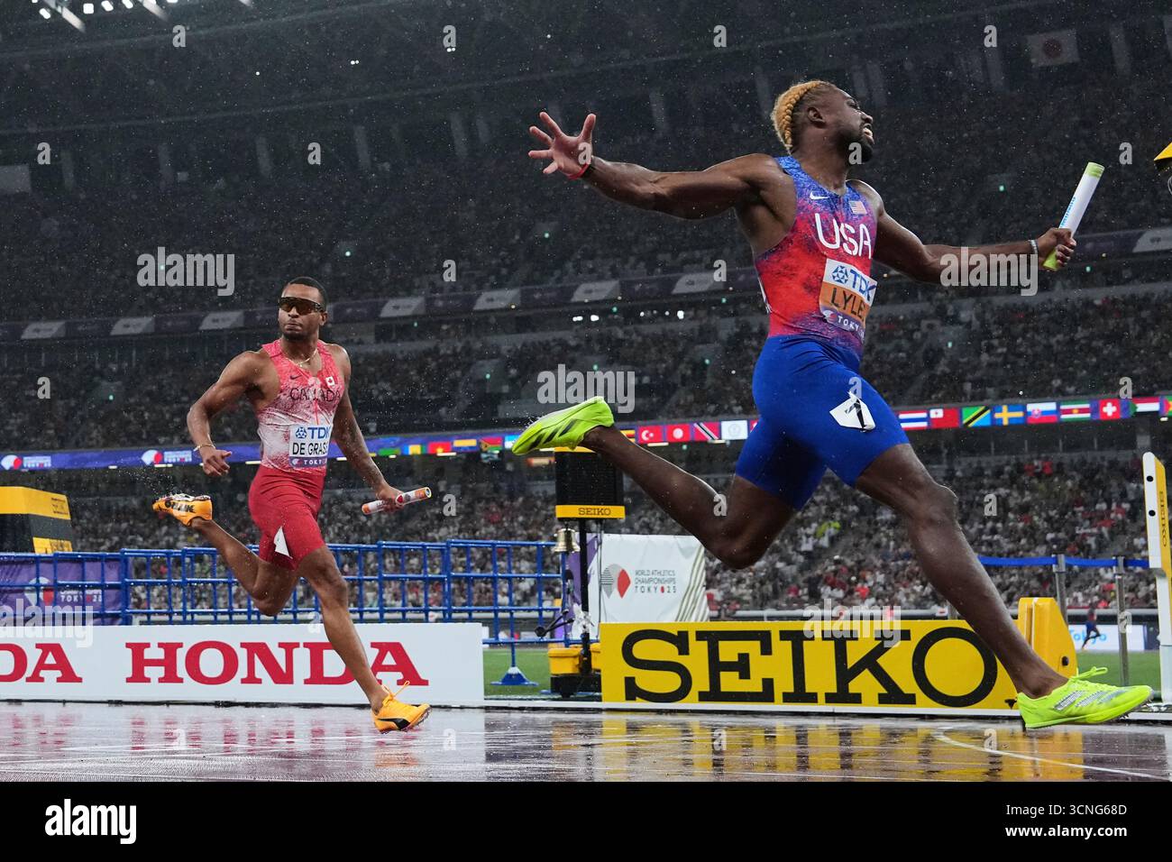United States' Noah Lyles, right, crosses the finish line in first ...