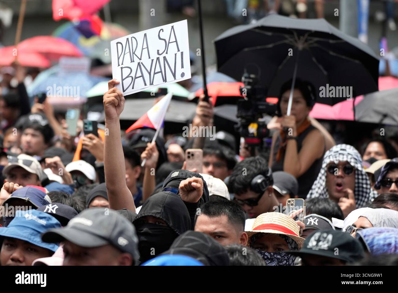 A protester holds a slogan that reads: "For the Nation", as they attend ...