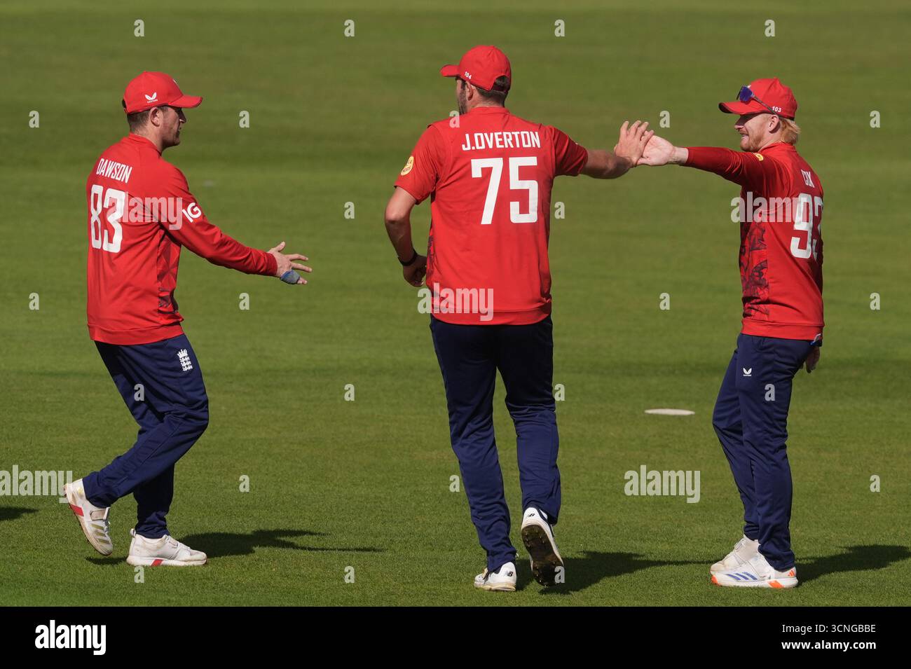 England's Jordan Cox (right) celebrates with Liam Dawson (centre) and ...
