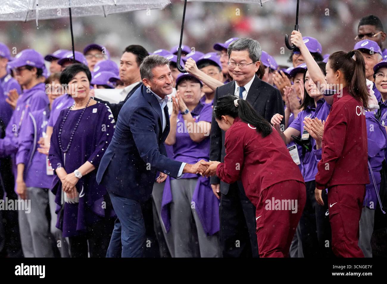 Sebastian Coe greets Chinese athletes during closing ceremonies at the ...