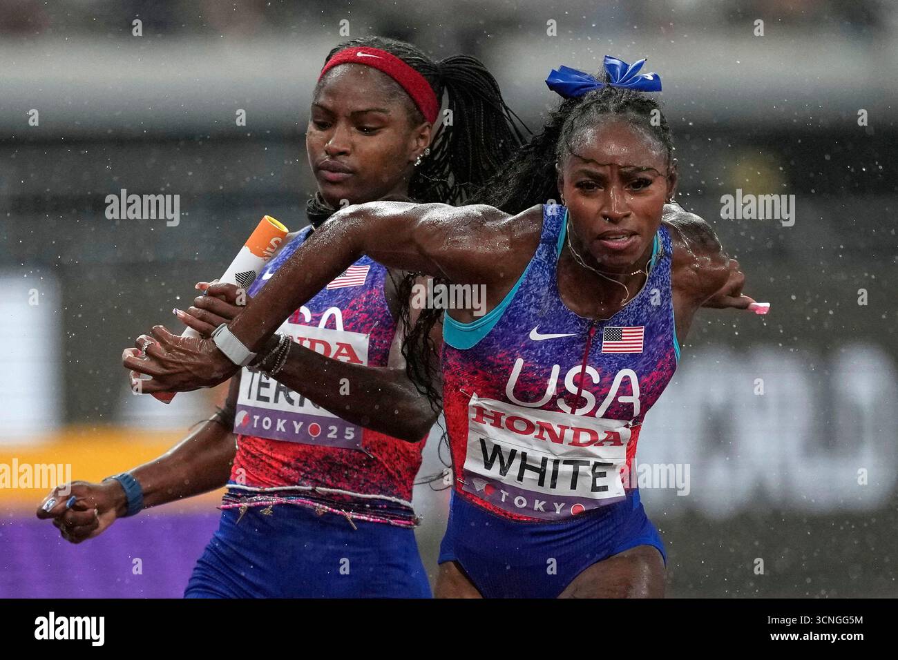 United States' Twanisha Terry passes the baton to Kayla White in the ...