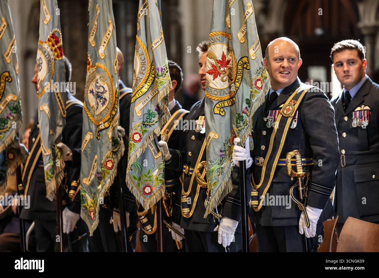 Royal Air Force personnel carry squadron flags inside Westminster Abbey ...