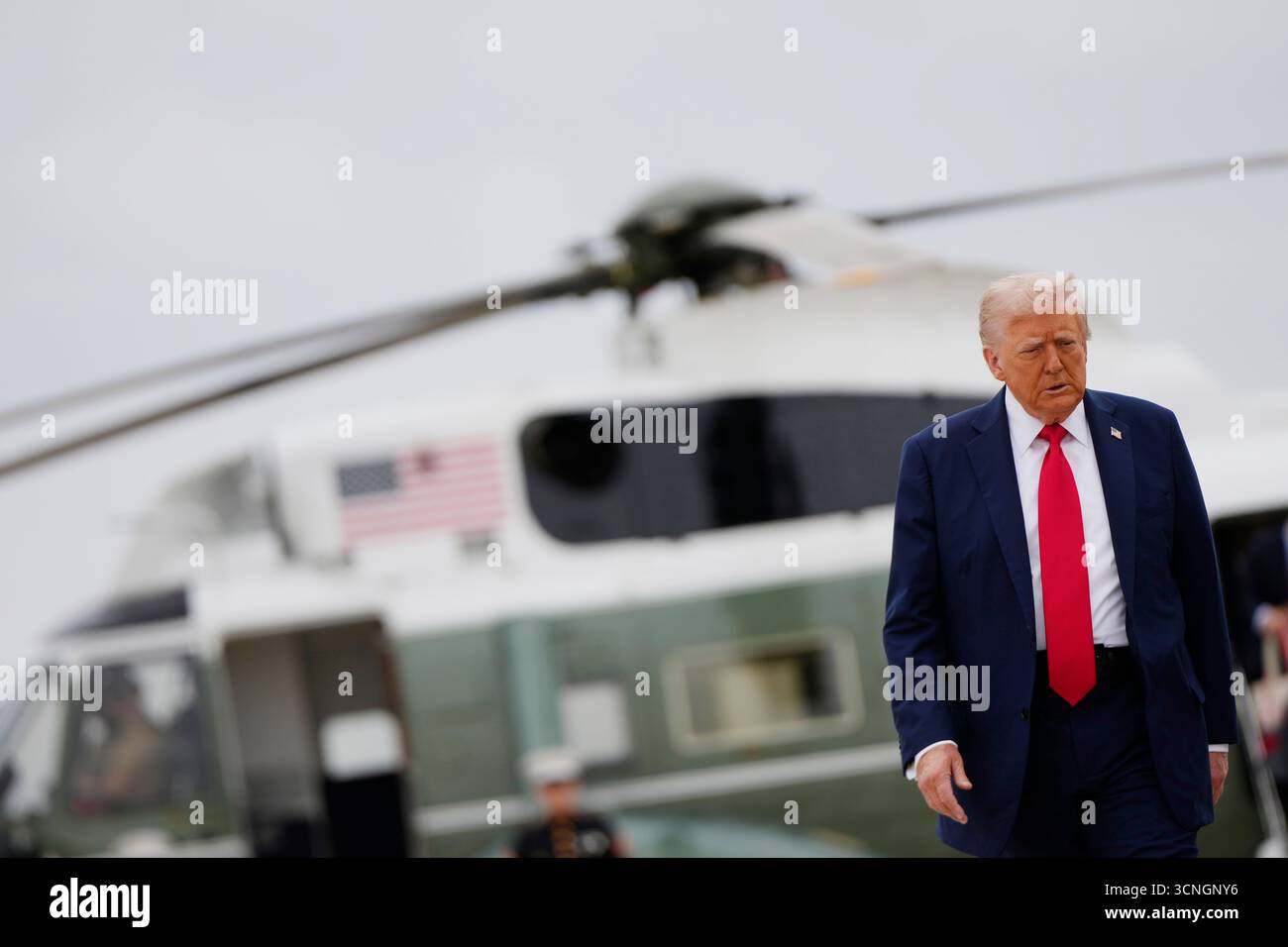 President Donald Trump walking across the tarmac before boarding Air ...