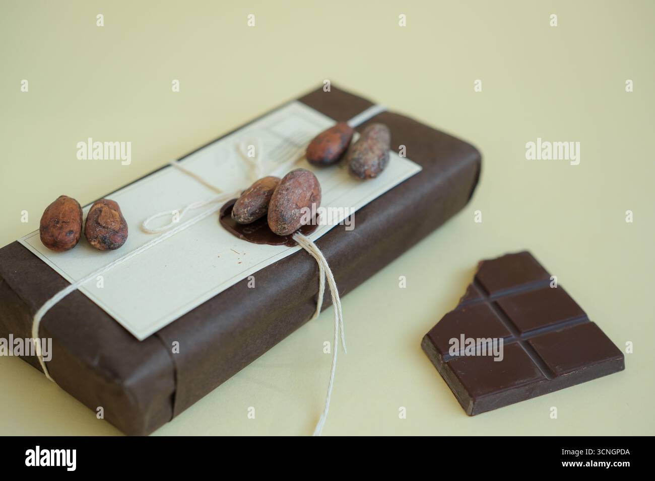 Chocolate parcel with sealing wax in sustainable packaging. Cocoa beans ...