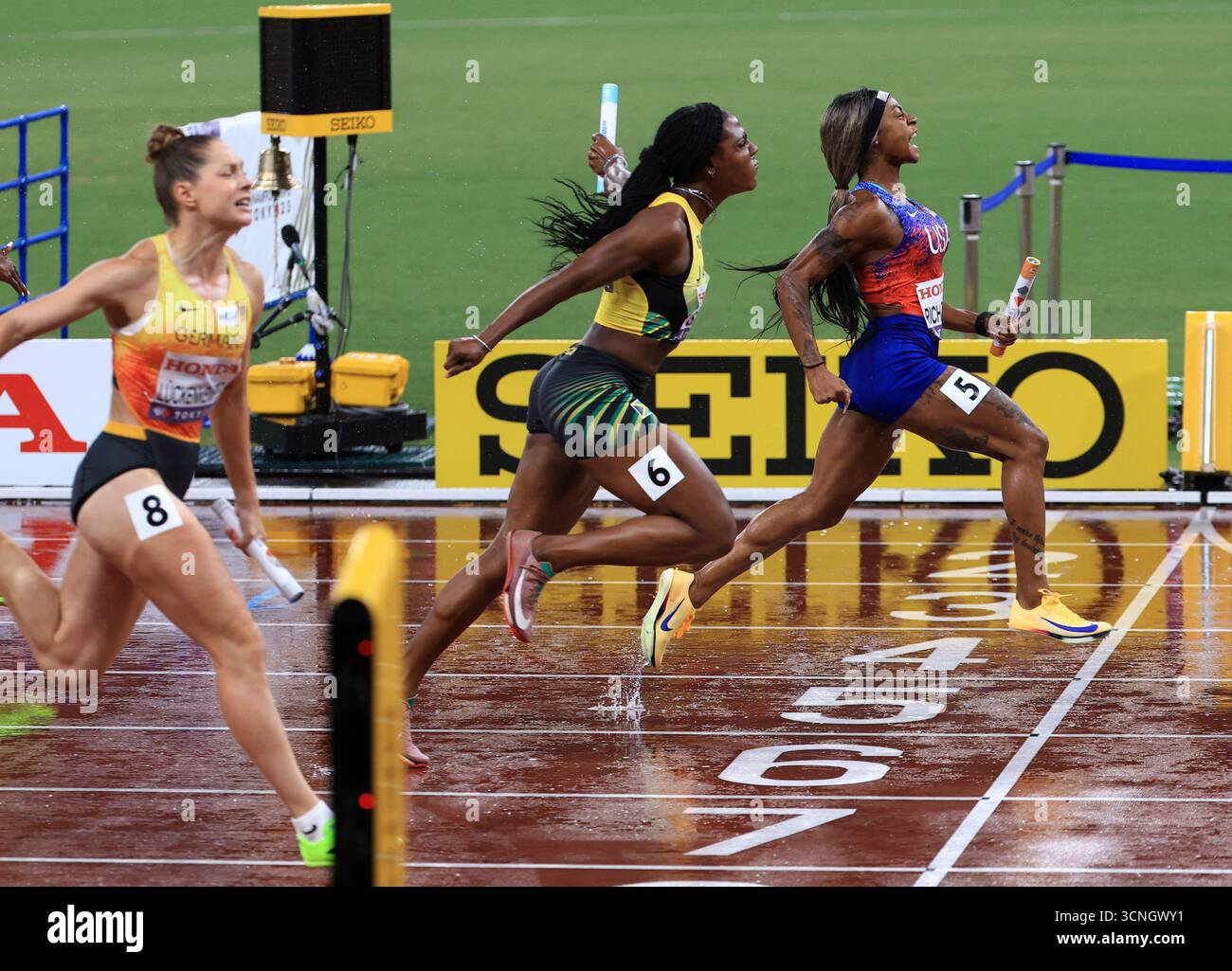 Sha'Carri RICHARDSON of United States (R) crosses the finish line to ...