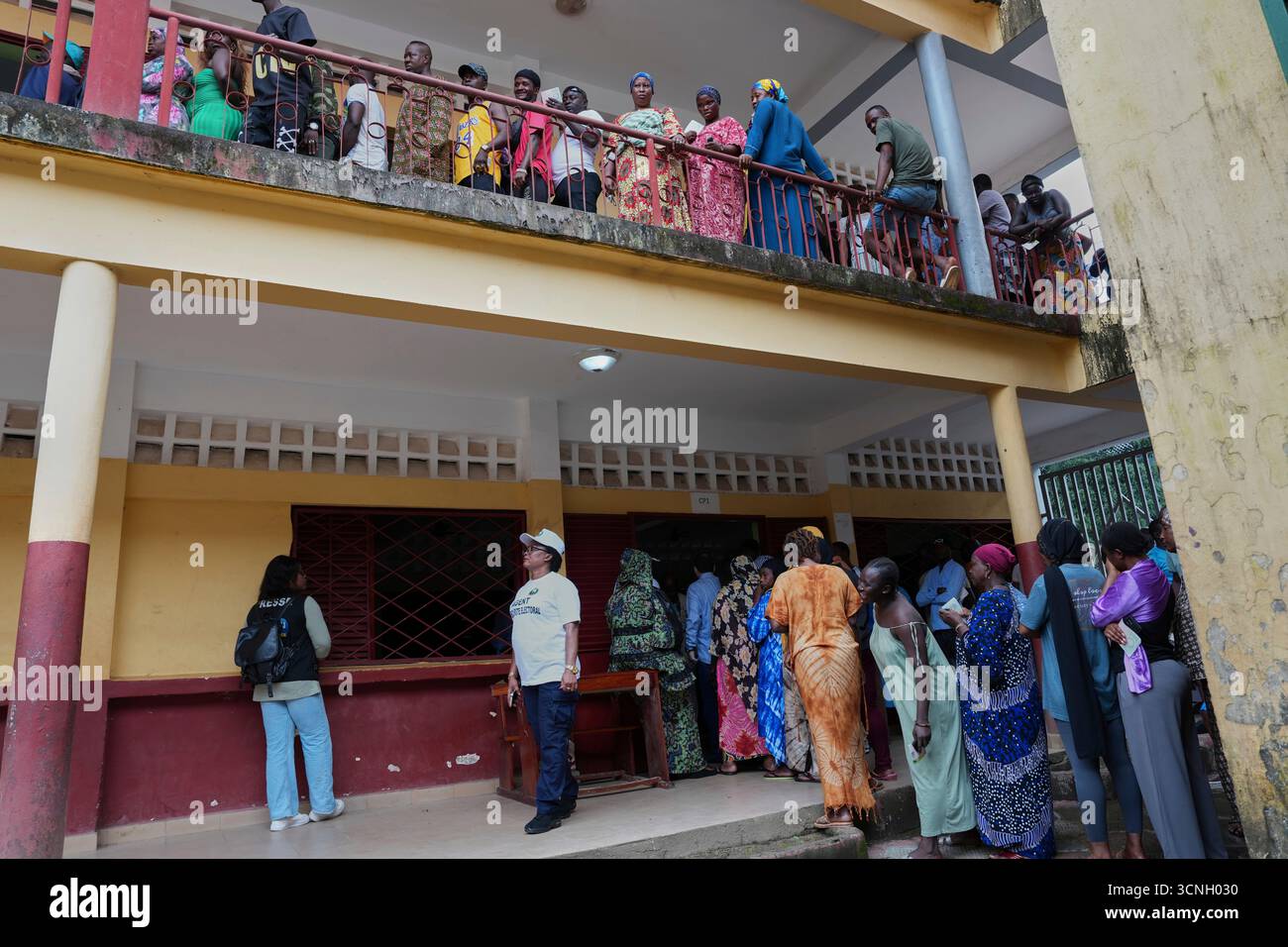 Voters queue to cast their votes in the constitutional referendum, in ...