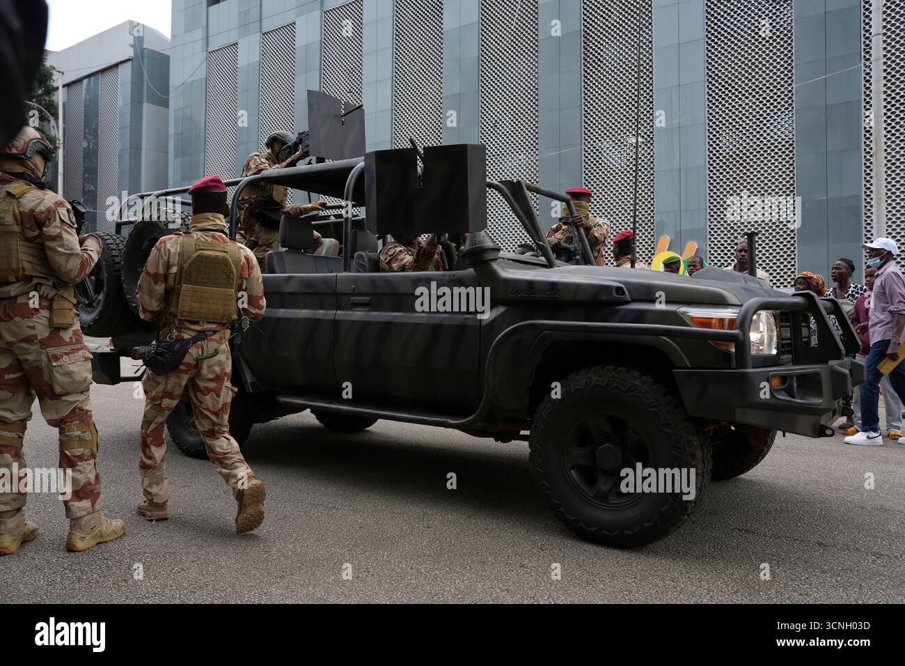 Guinean soldiers leave a polling station where Gen. Mamady Doumbouya ...