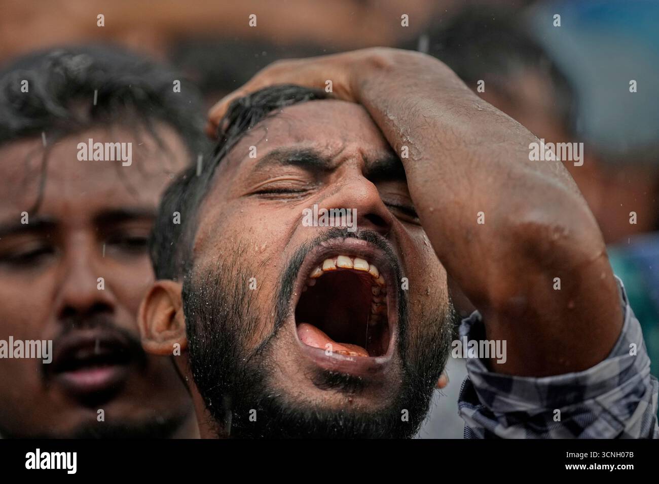 A fan cries as he pays homage to the popular Bollywood singer and ...