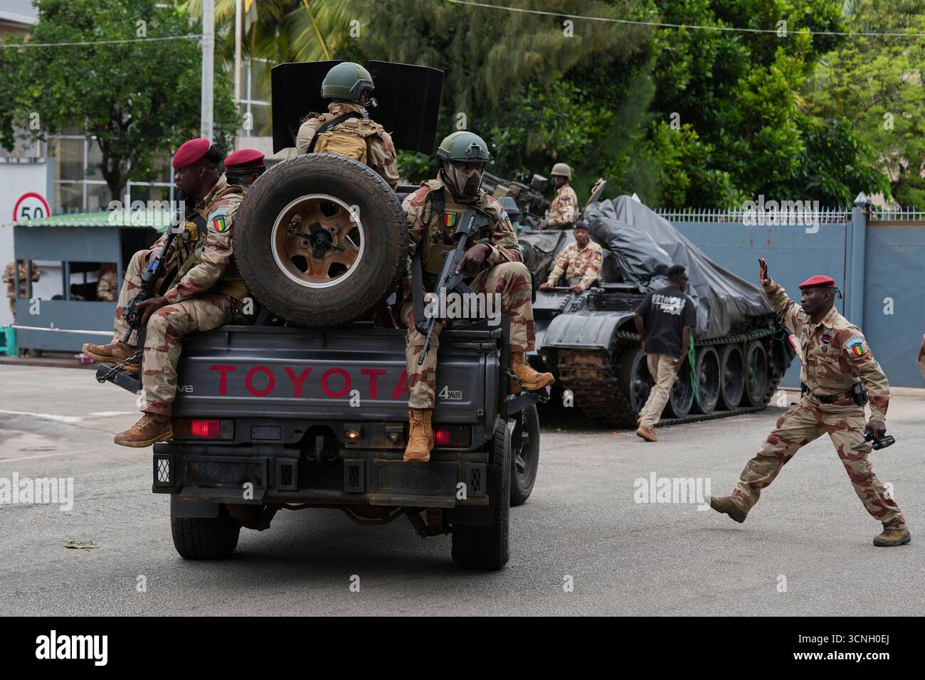 Guinean soldiers leave a polling station where Gen. Mamady Doumbouya ...