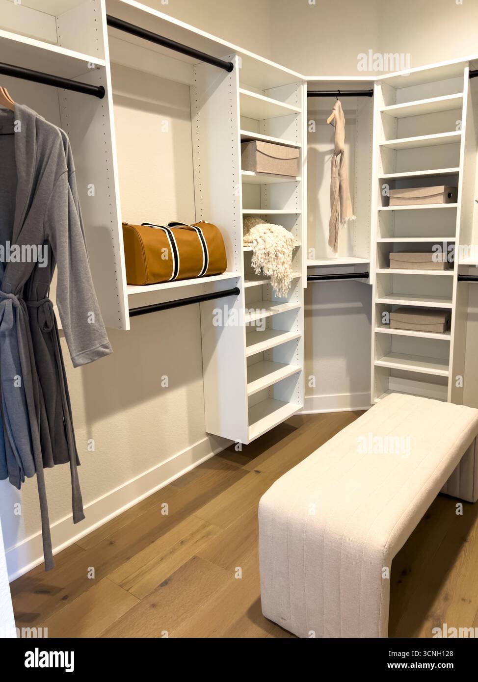 Walk-In Closet with Open Shelving and Bench Stock Photo - Alamy