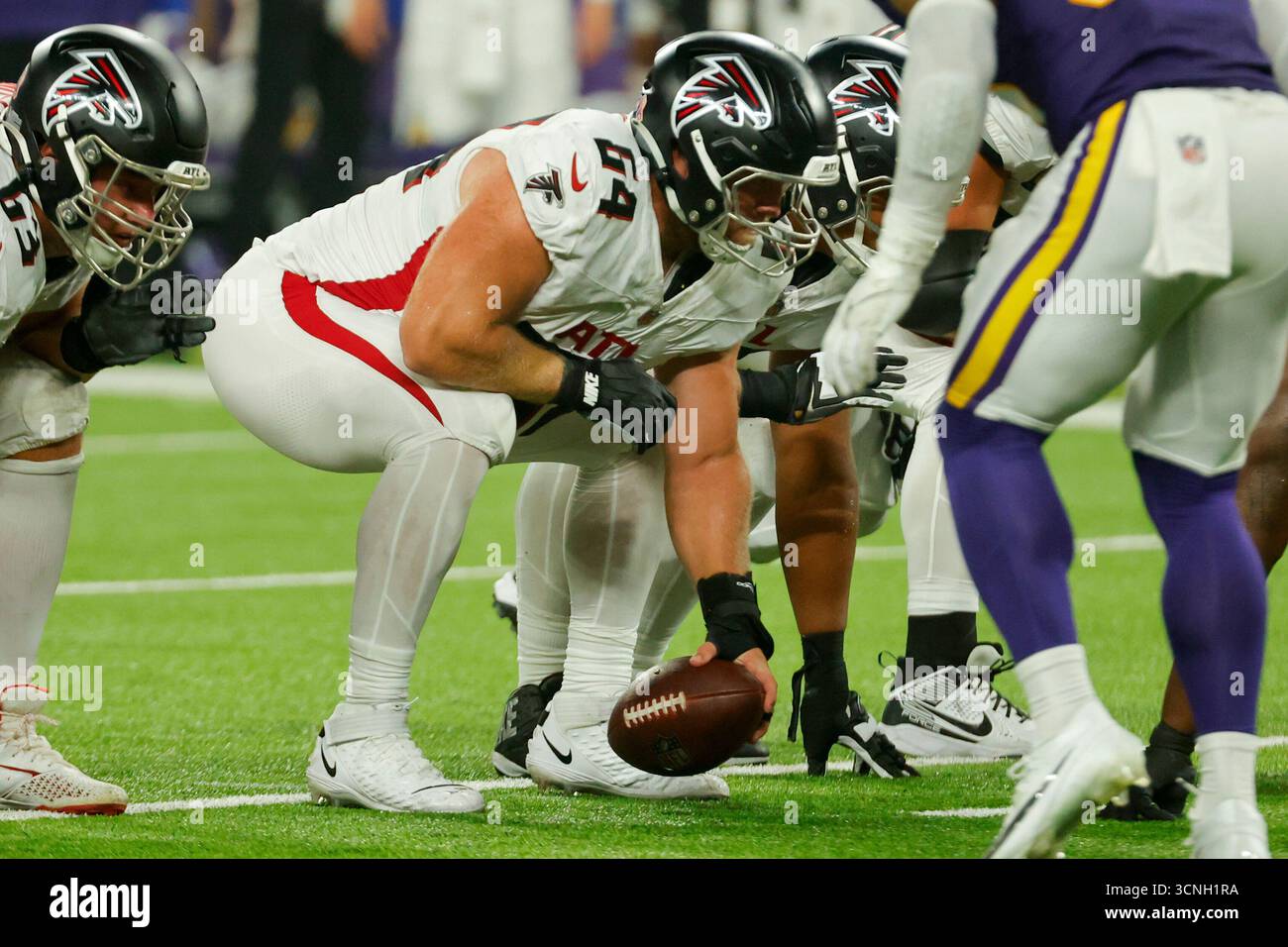 Atlanta Falcons guard Ryan Neuzil (64) snaps the ball against the ...