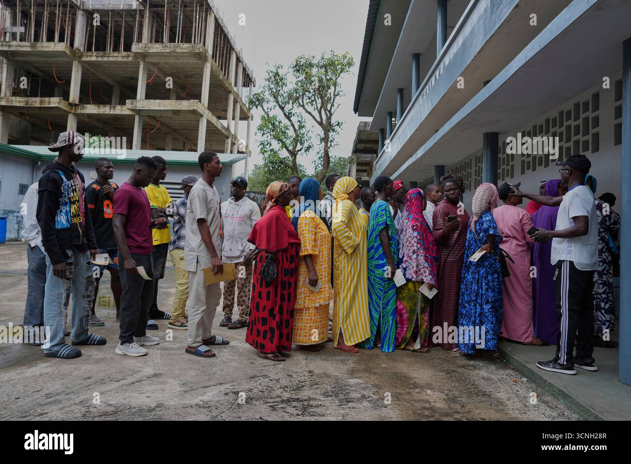 Voters queue to cast their votes in the constitutional referendum, in ...