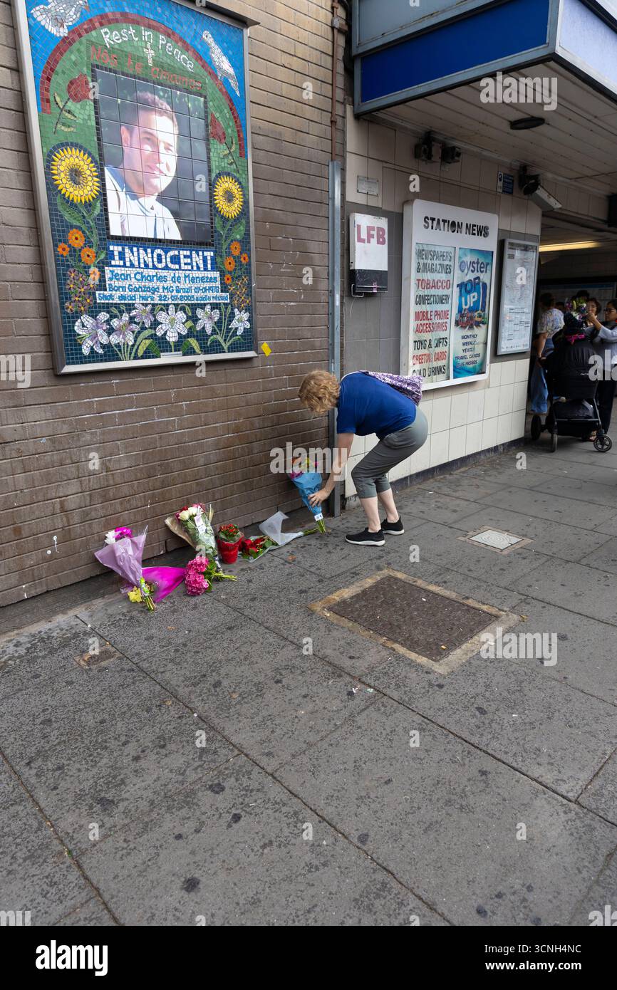 A person lays flowers at the memorial of Jean Charles de Menezes ...