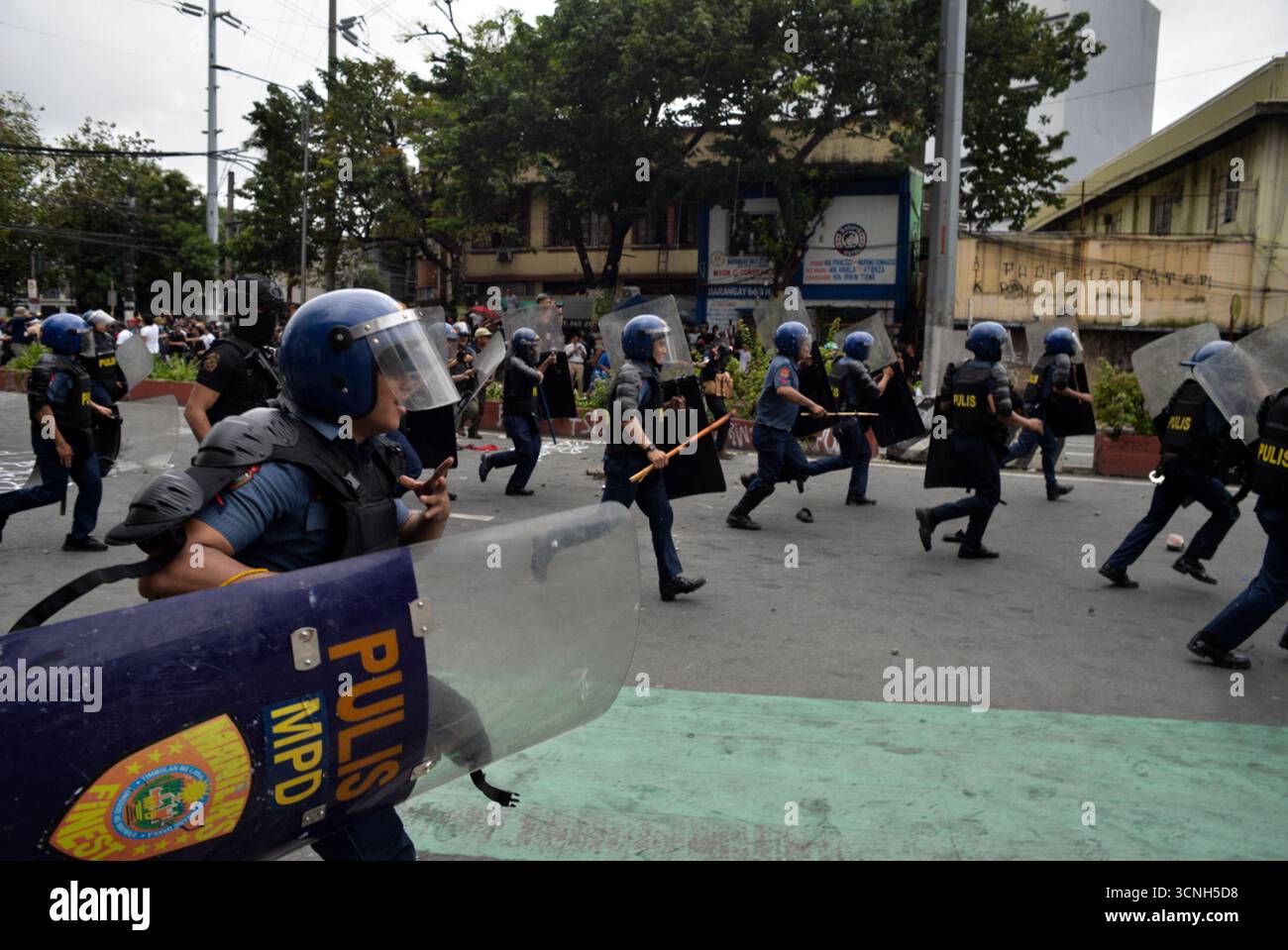 Protesters clash with anti-riot police at Ayala Bridge, Manila, during ...