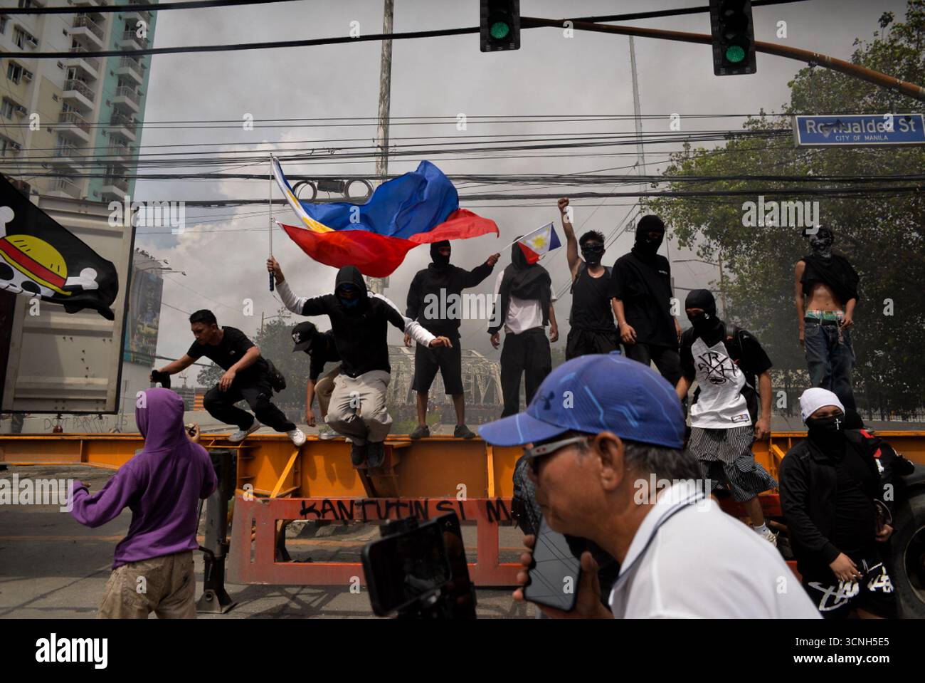 Protesters clash with anti-riot police at Ayala Bridge, Manila, during ...
