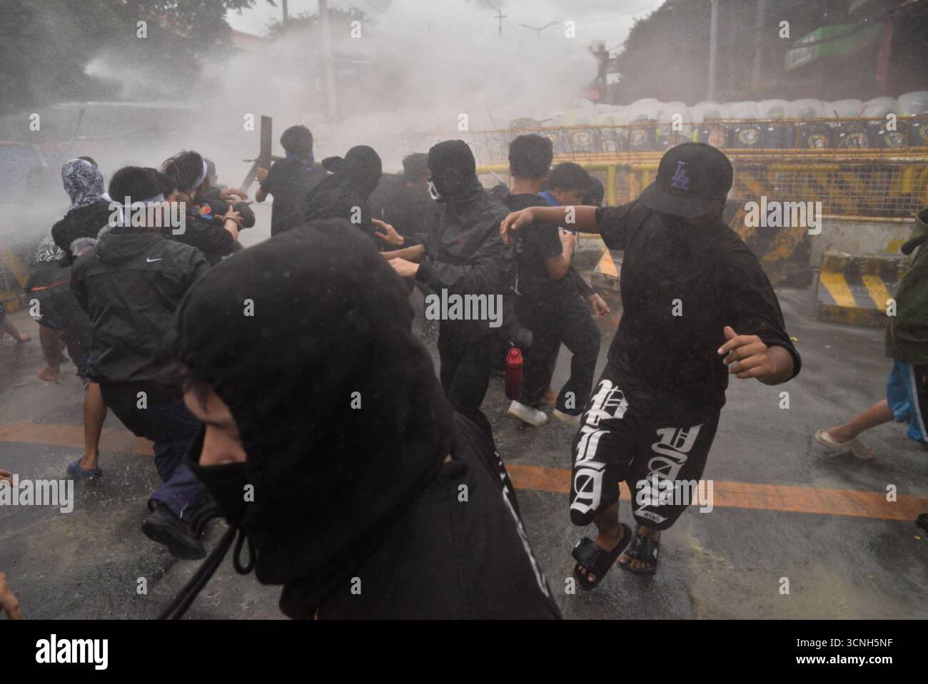 Protesters clash with anti-riot police at Ayala Bridge, Manila, during ...