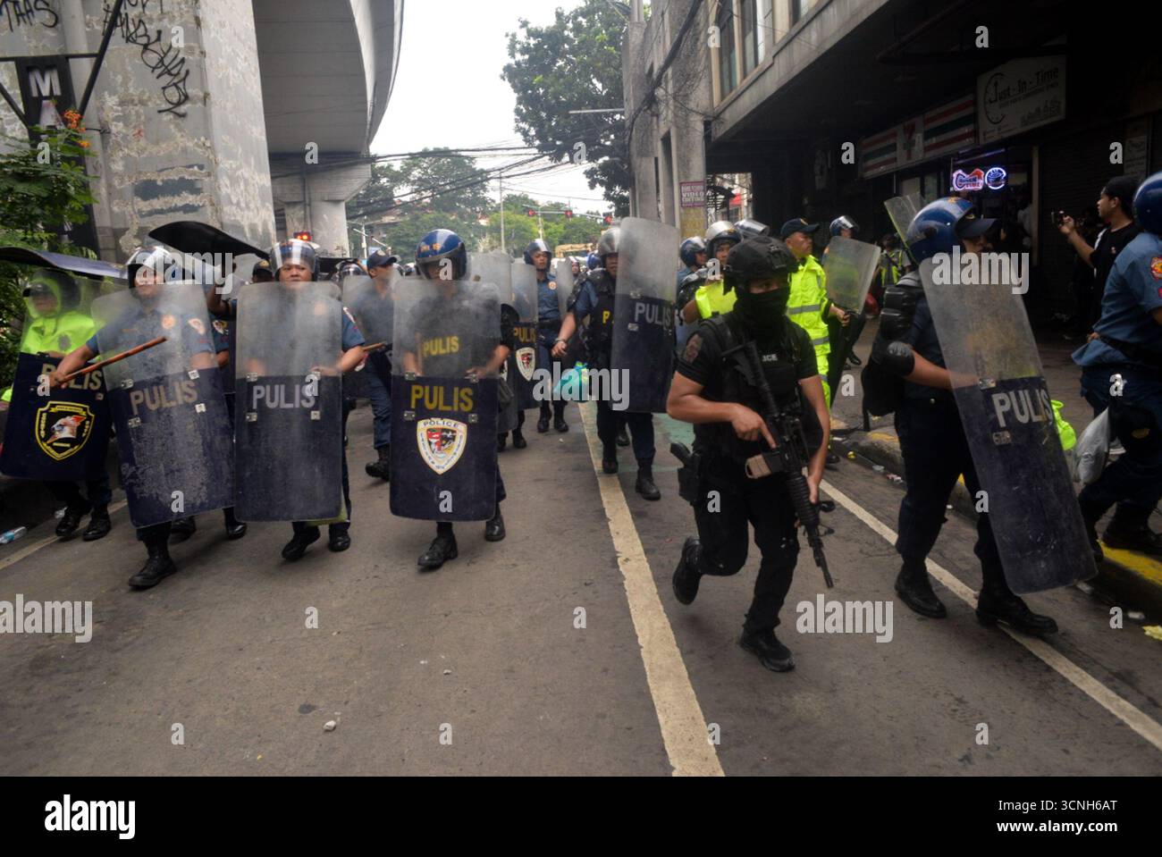 Protesters clash with anti-riot police at Ayala Bridge, Manila, during ...