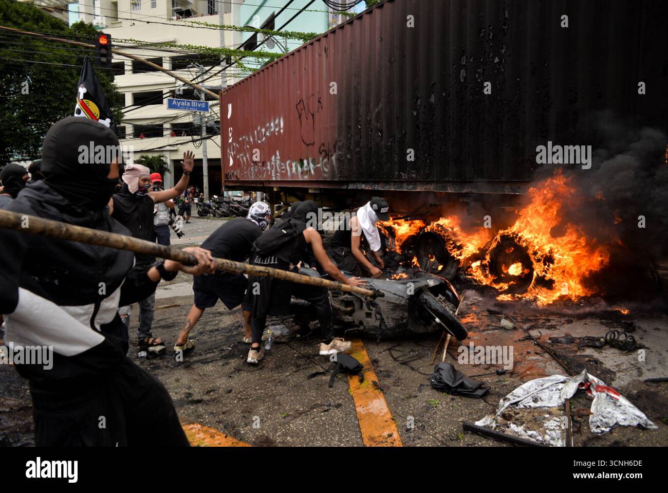 Protesters clash with anti-riot police at Ayala Bridge, Manila, during ...