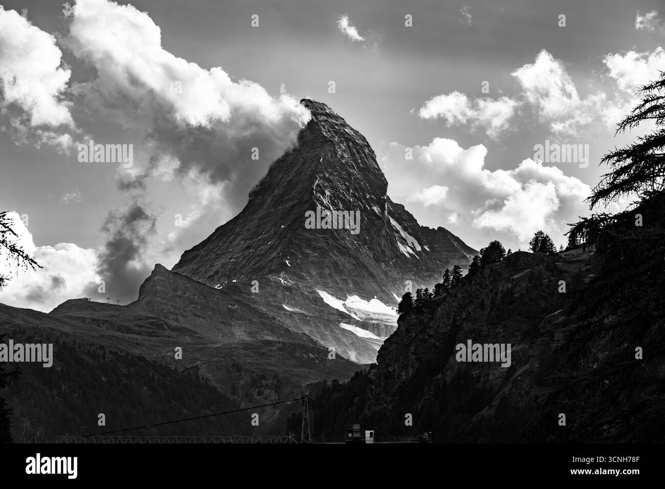 Snow-capped Swiss Alps mountains with a glacial waterfall and flowing ...