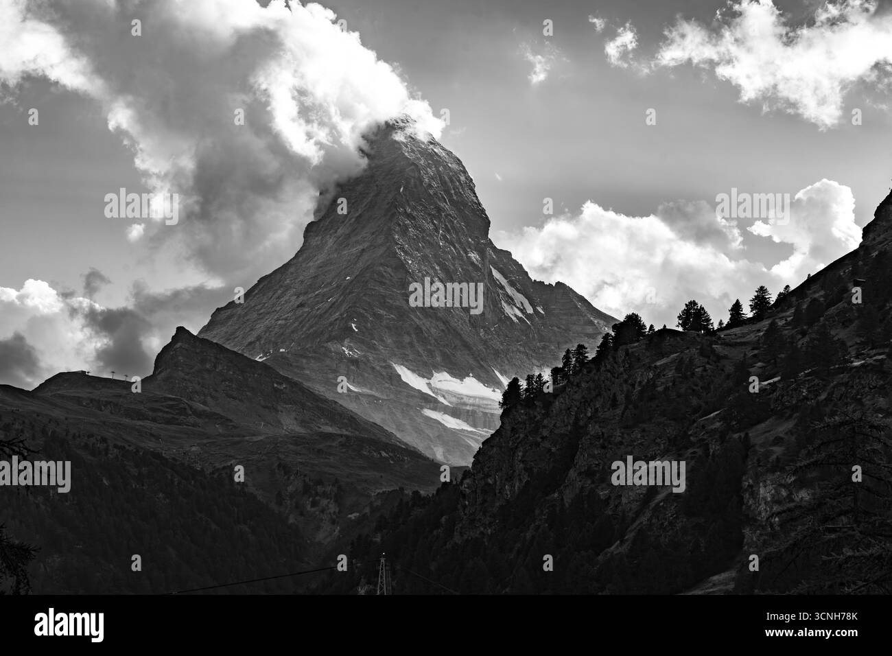 Snow-capped Swiss Alps mountains with a glacial waterfall and flowing ...