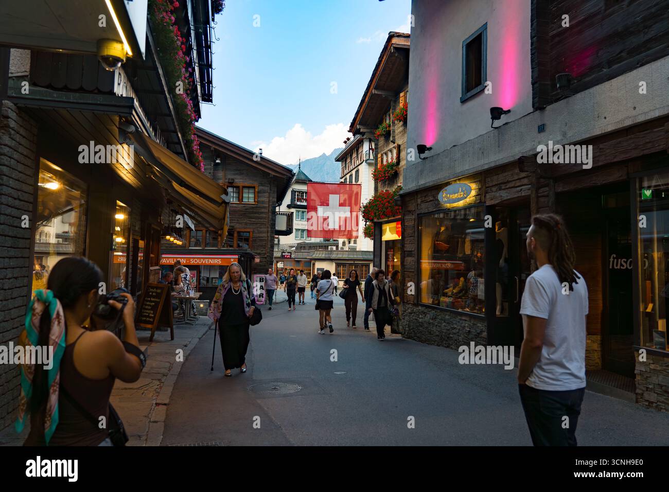Evening scene in Zermatt town center with tourists, restaurants, shops ...