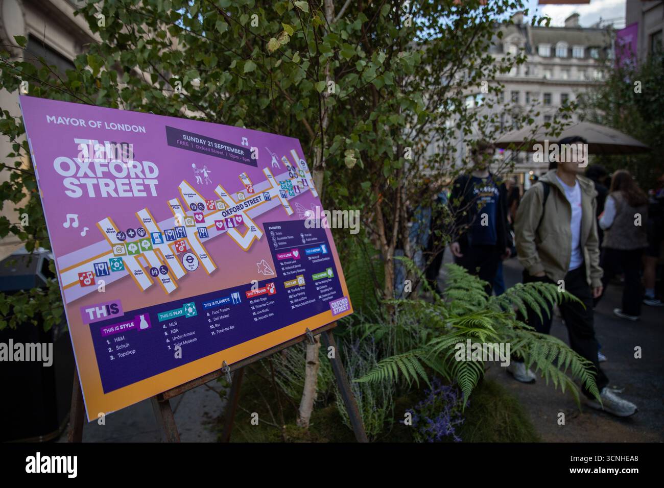 People walk past an information sign on Oxford Street during a car free day. Following Mayor Sir ...