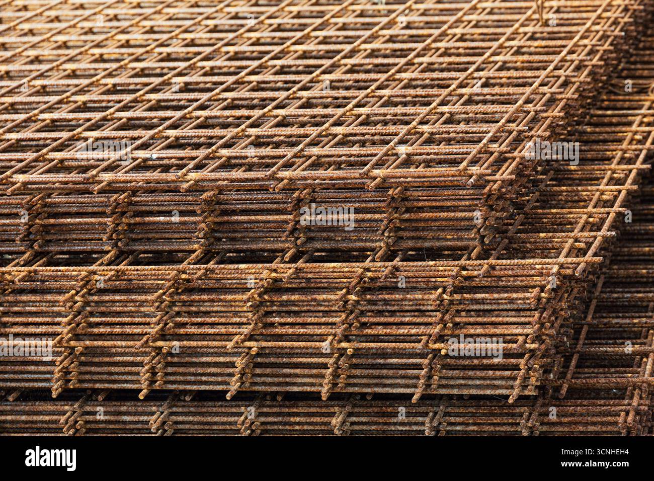 Stacked rusty rebar grids creating a textured pattern, ready for use in ...