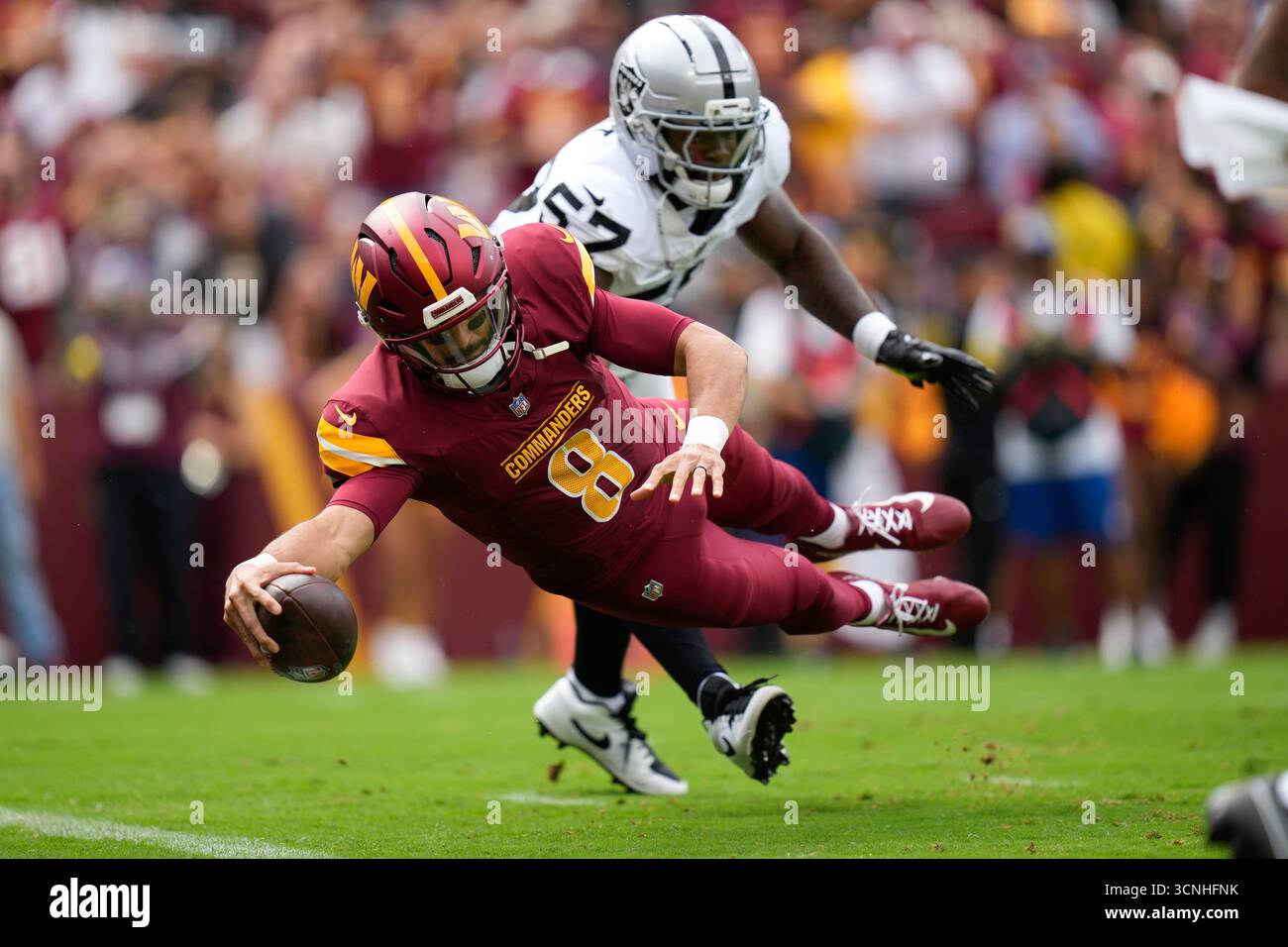 Washington Commanders quarterback Marcus Mariota (8) scores a touchdown ...
