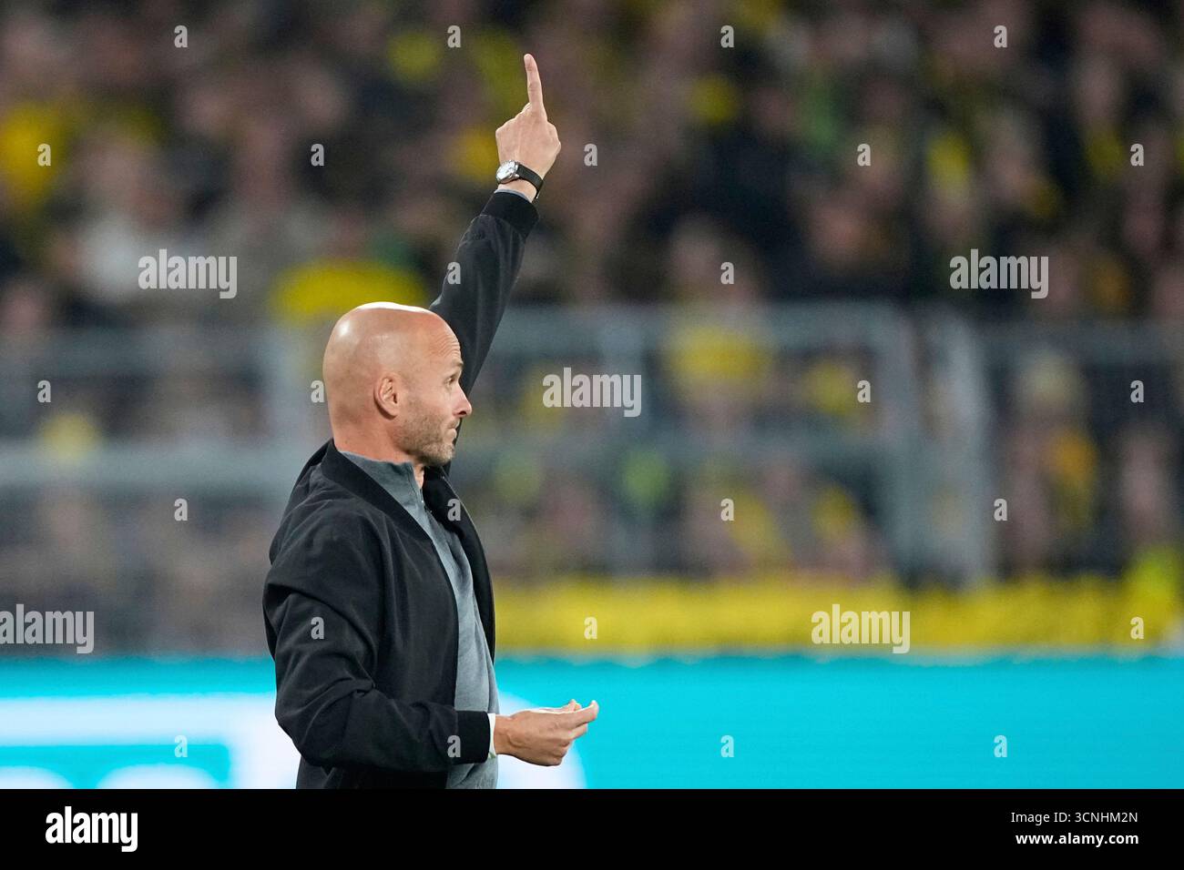 Wolfsburg's head coach Paul Simonis gives instructions to his players ...
