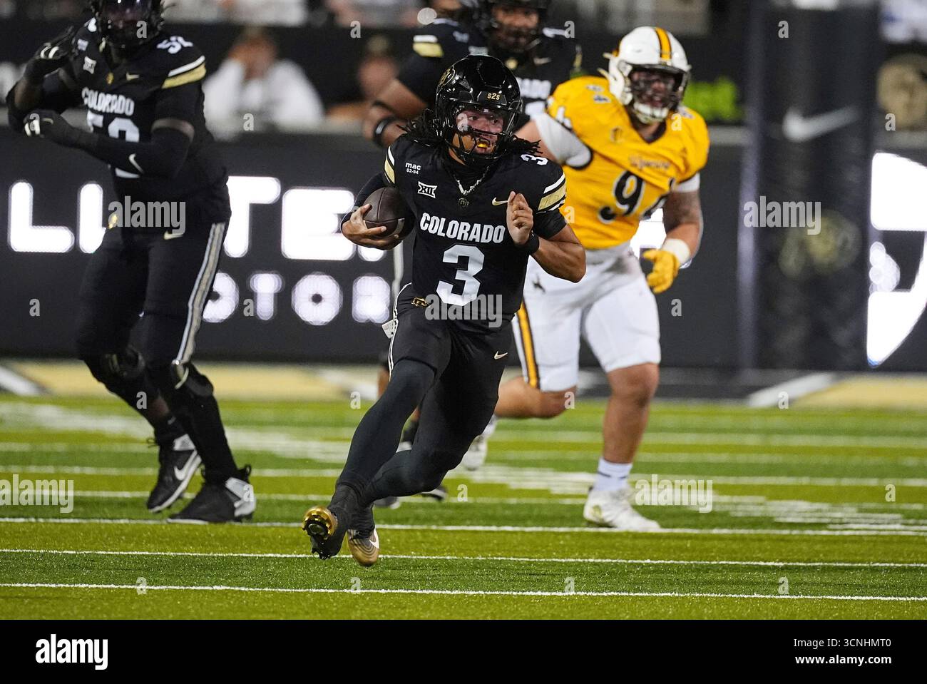 Colorado quarterback Kaidon Salter (3) runs past Wyoming linebacker Brayden Johnson (9) in the ...