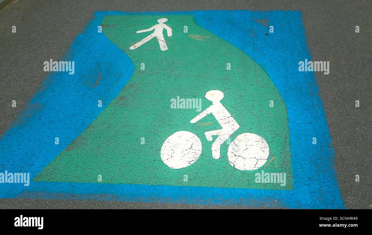 Marking of a shared bicycle and pedestrian path with painted symbols in ...