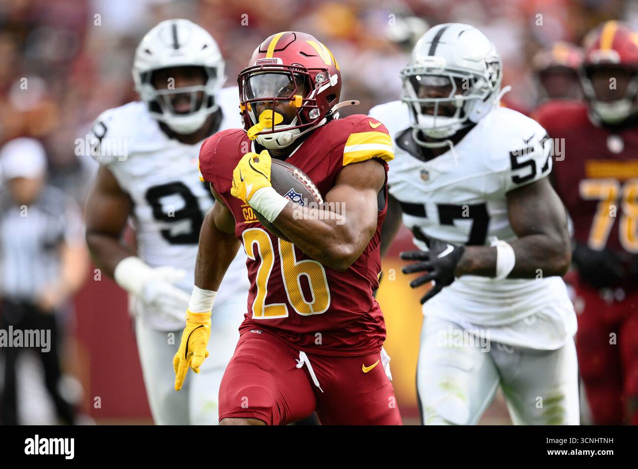 Washington Commanders running back Jeremy McNichols (26) runs in a ...