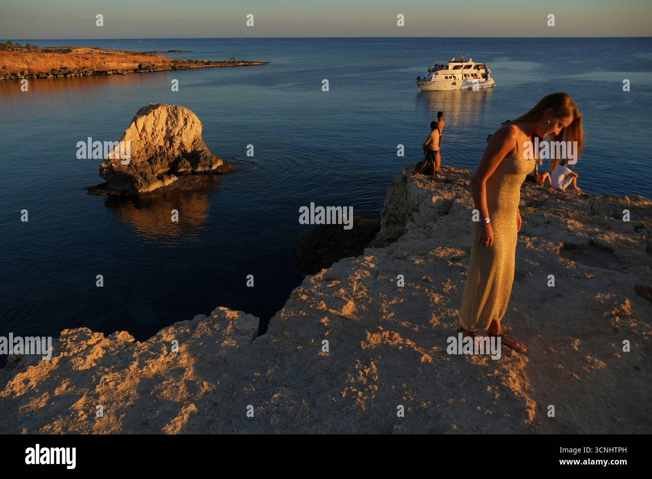 Tourist enjoy the sunset at the 'Love' natural bridge at the southeast ...