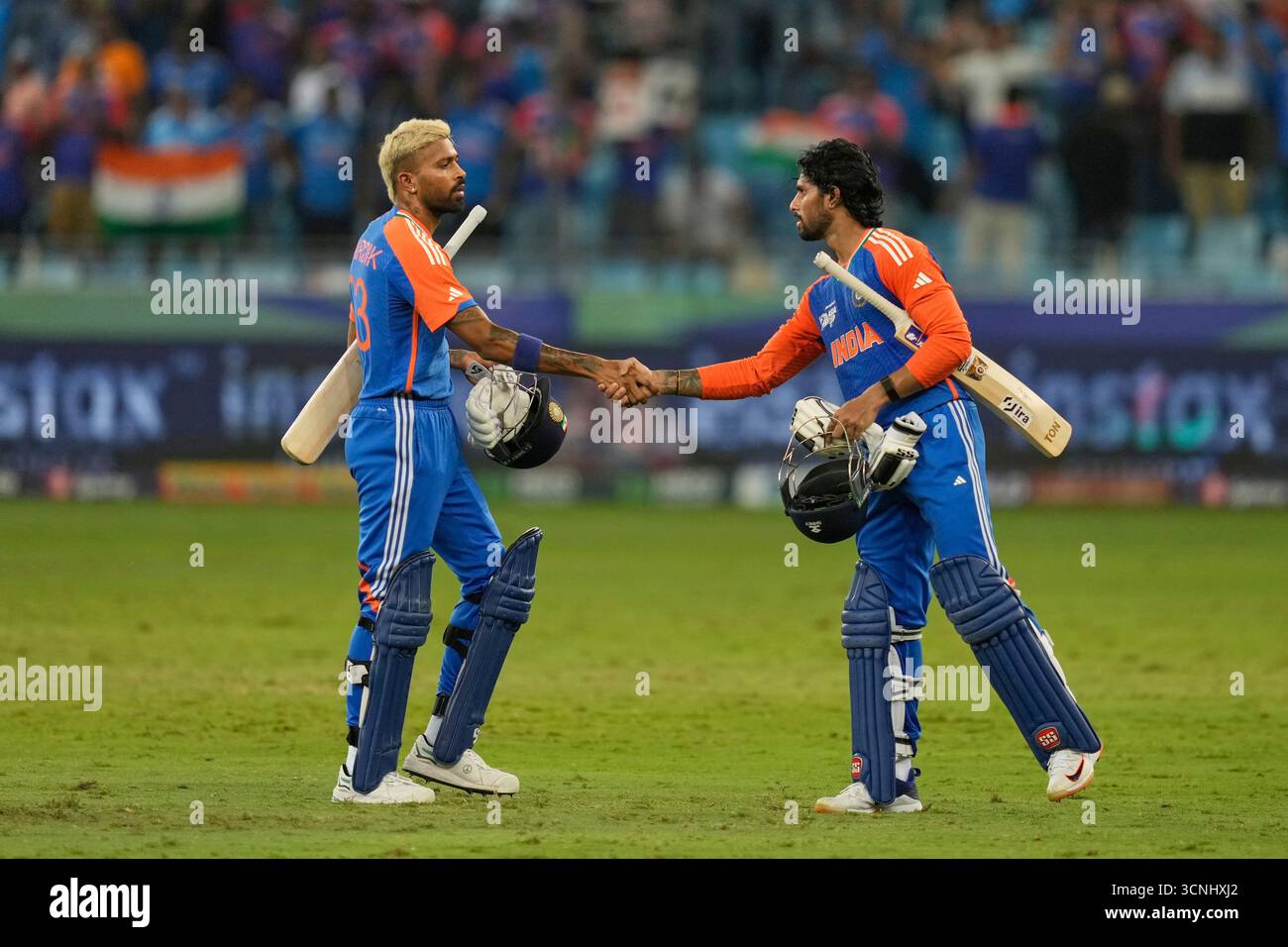 India's Hardik Pandya and Tilak Varma shake hands after wining during the Asia Cup cricket match ...