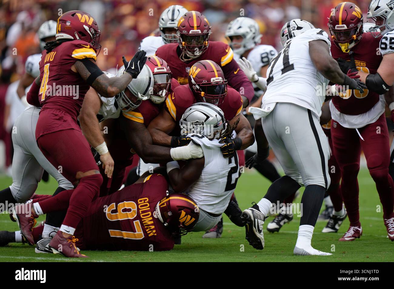 Las Vegas Raiders running back Ashton Jeanty (2) holds on to the ball ...